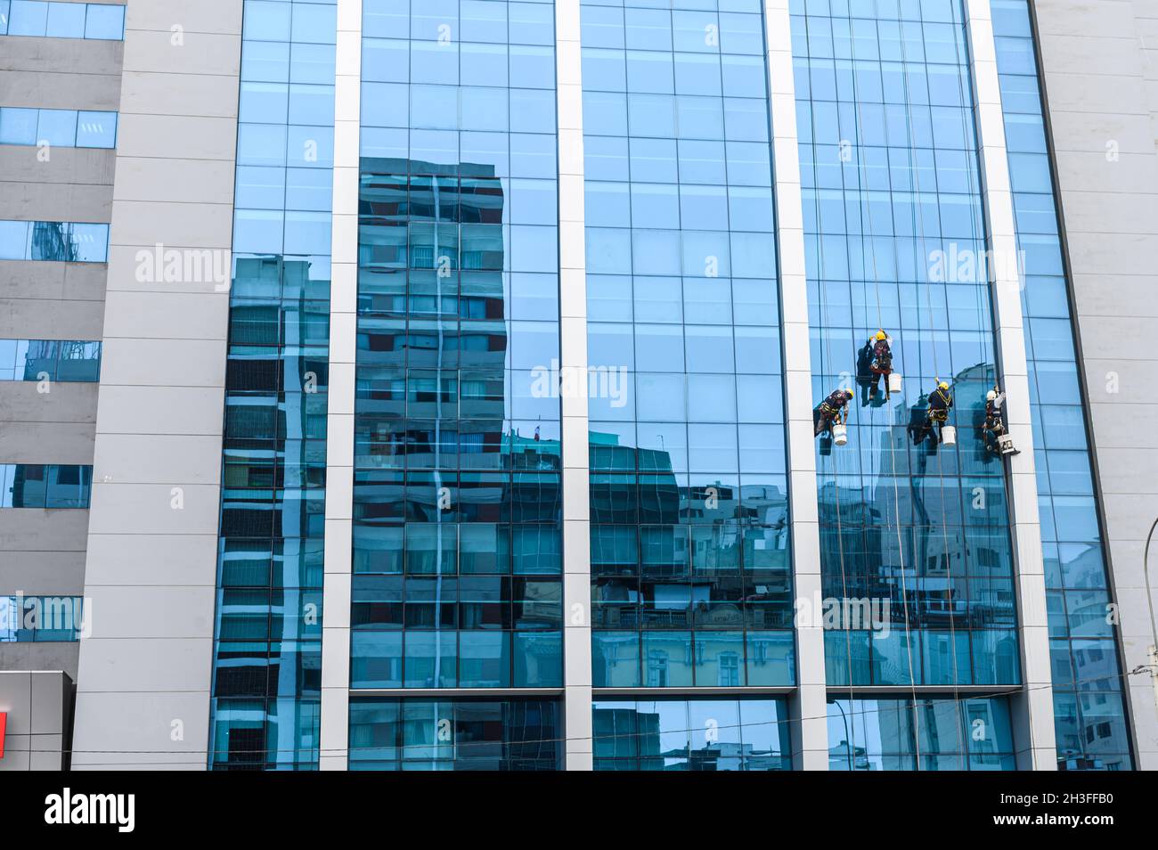 group of workers cleaning windows service on high rise building Stock ...