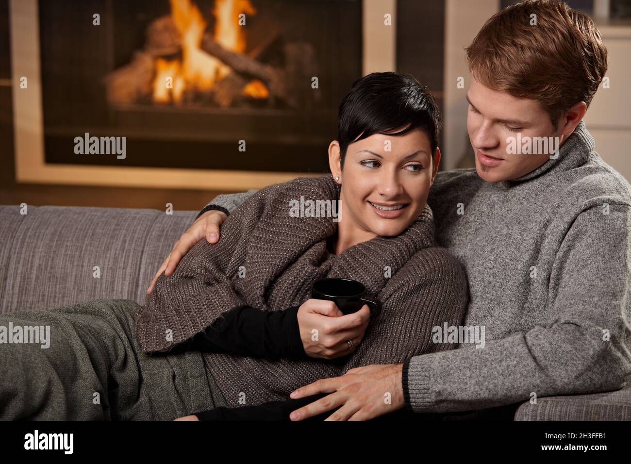 Couple hugging at home Stock Photo - Alamy
