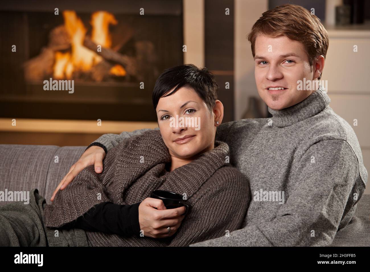 Couple hugging at home Stock Photo - Alamy