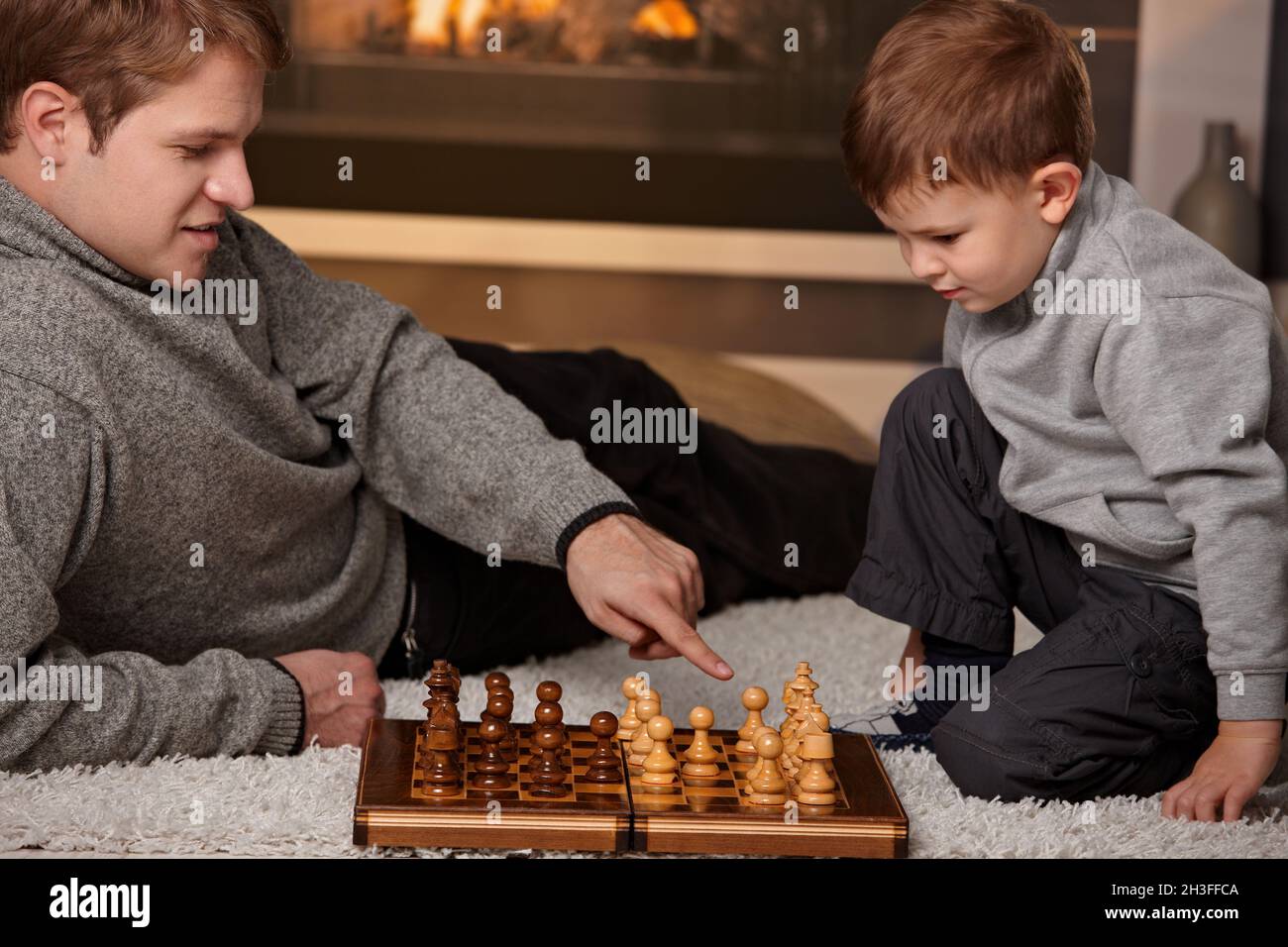 Father and son playing chess Stock Photo - Alamy