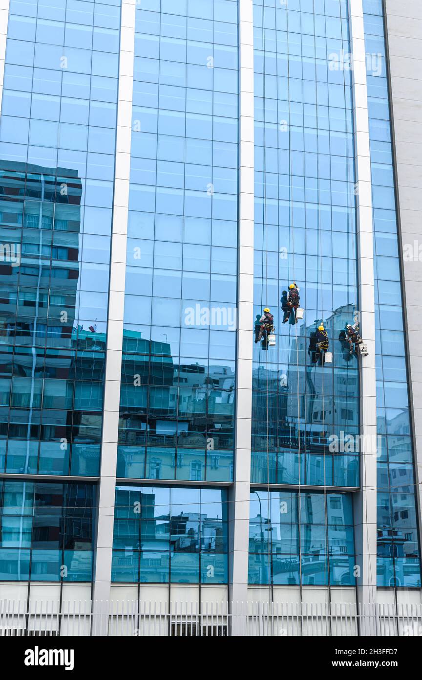 group of workers cleaning windows service on high rise building Stock ...