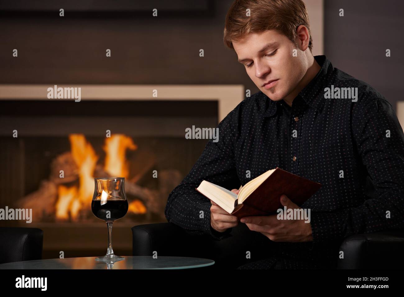 Young man reading book Stock Photo - Alamy