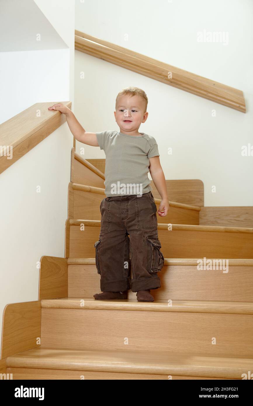 Boy on stairs with railing hi-res stock photography and images - Alamy