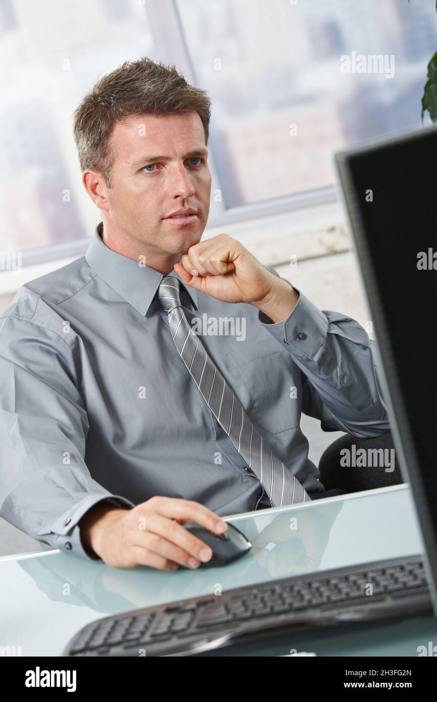 Businessman focusing on task Stock Photo - Alamy