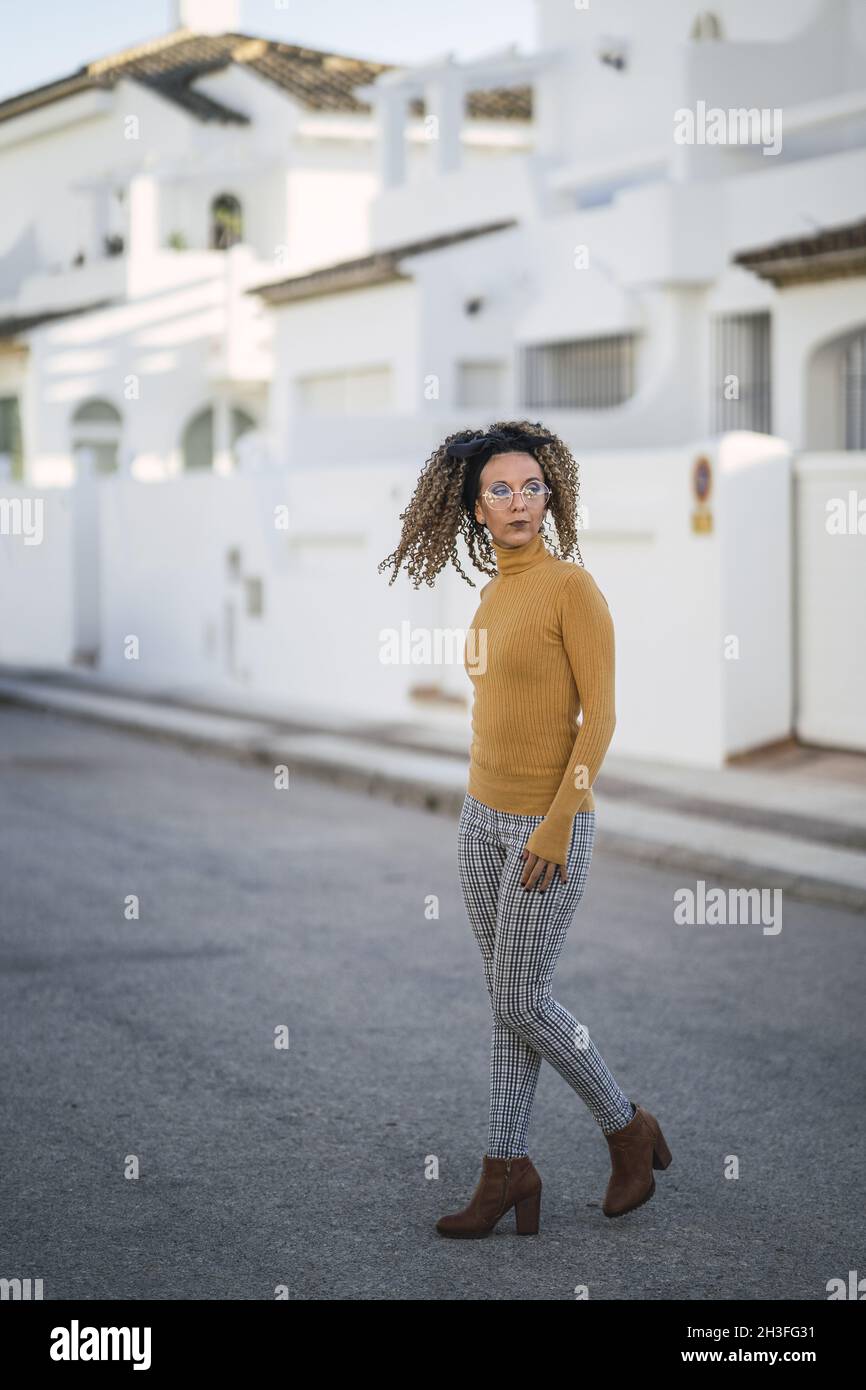Vertical shot of a Spanish female posing near the building Stock Photo ...