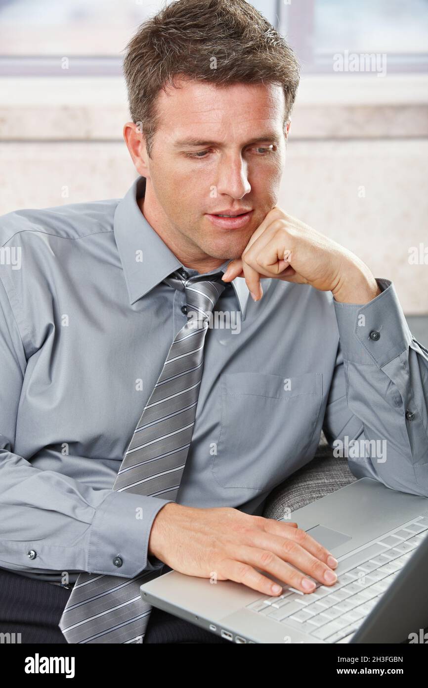 Professional looking down at computer Stock Photo - Alamy