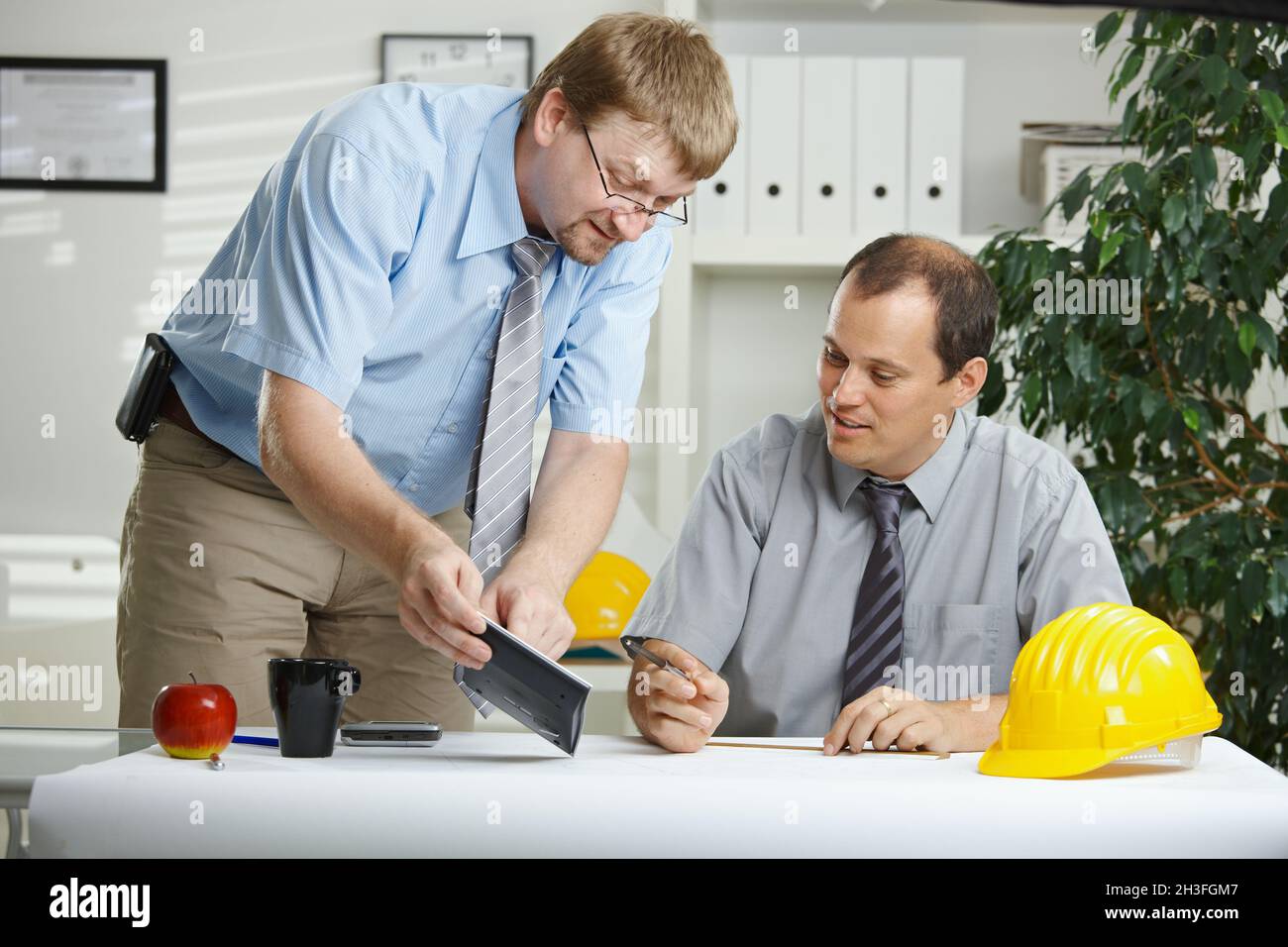 Engineers talking at office Stock Photo - Alamy