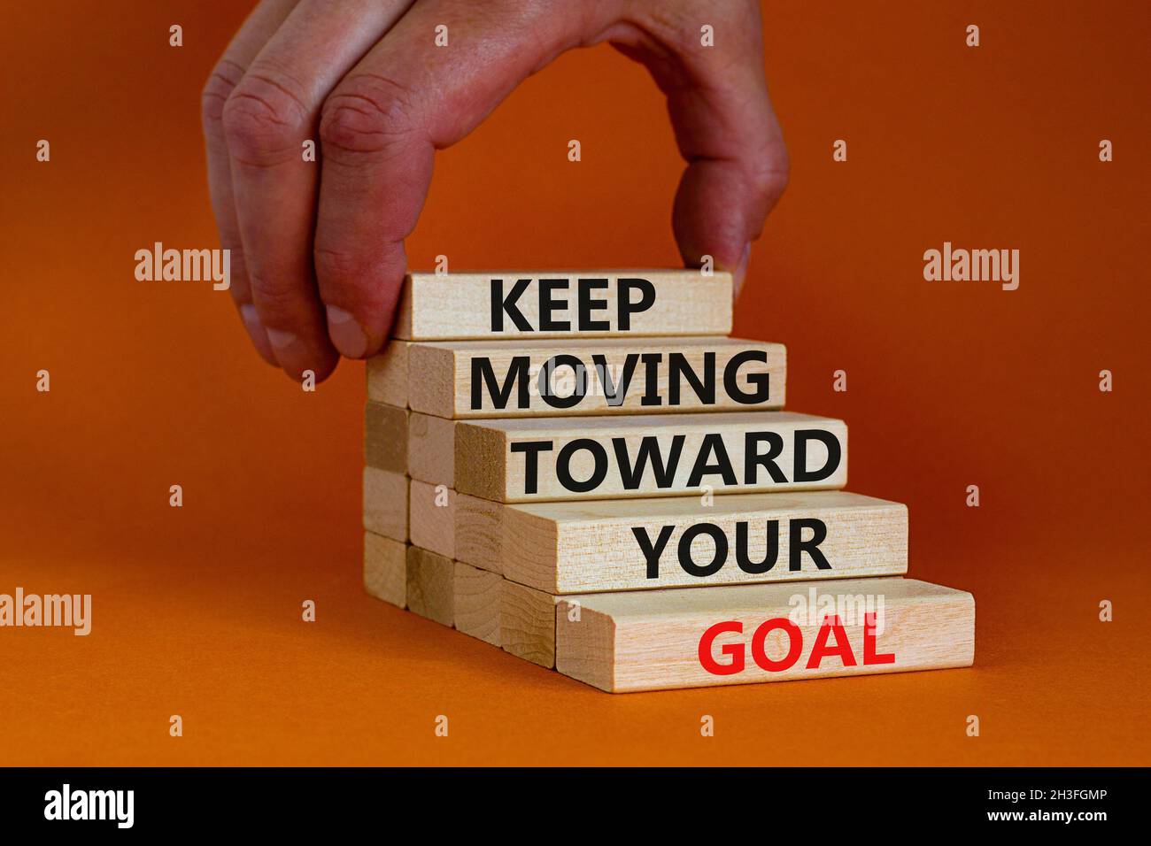 Keep moving toward your goal symbol. Wooden blocks with words Keep ...