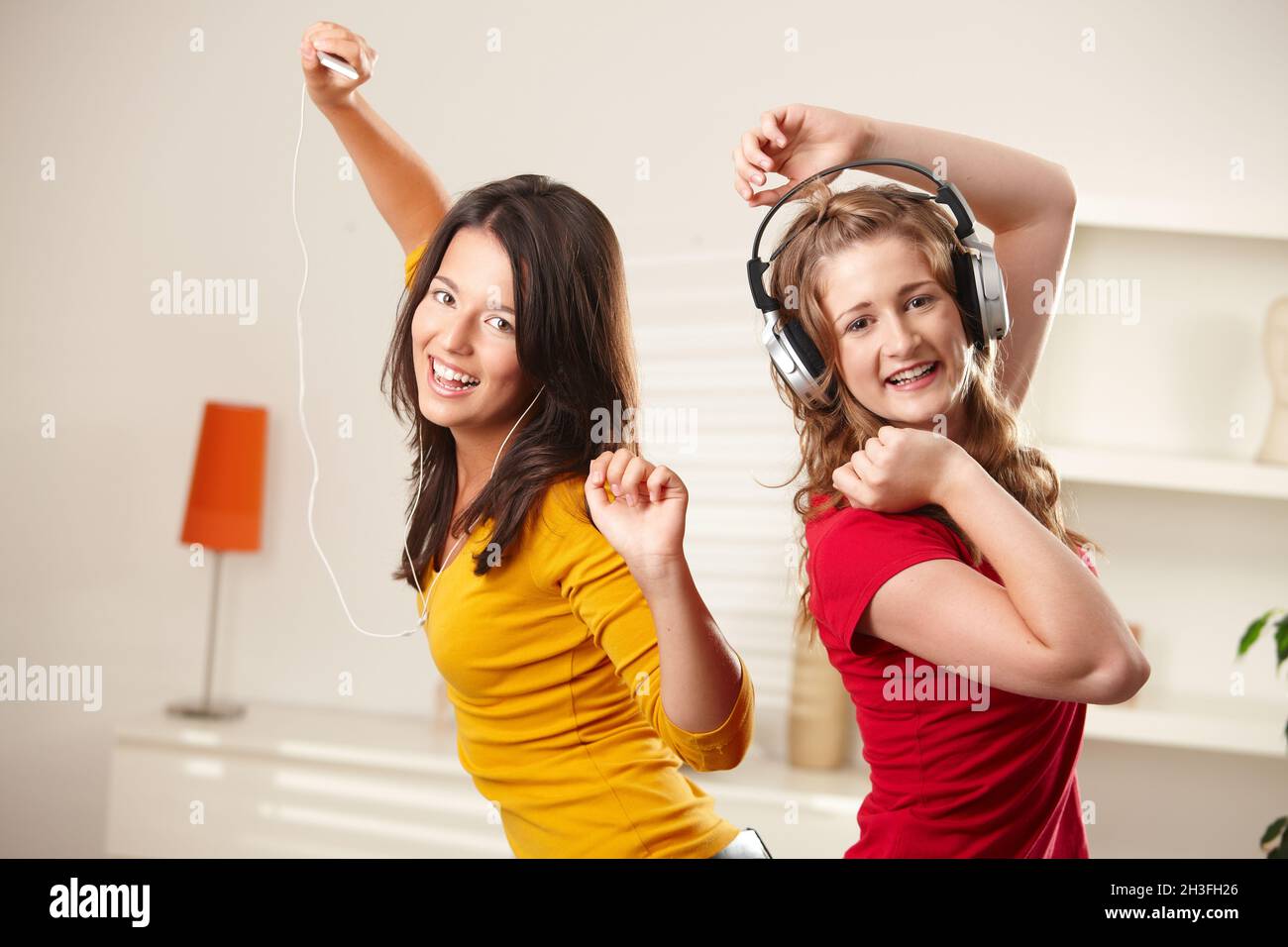 Happy girls dancing to music Stock Photo - Alamy