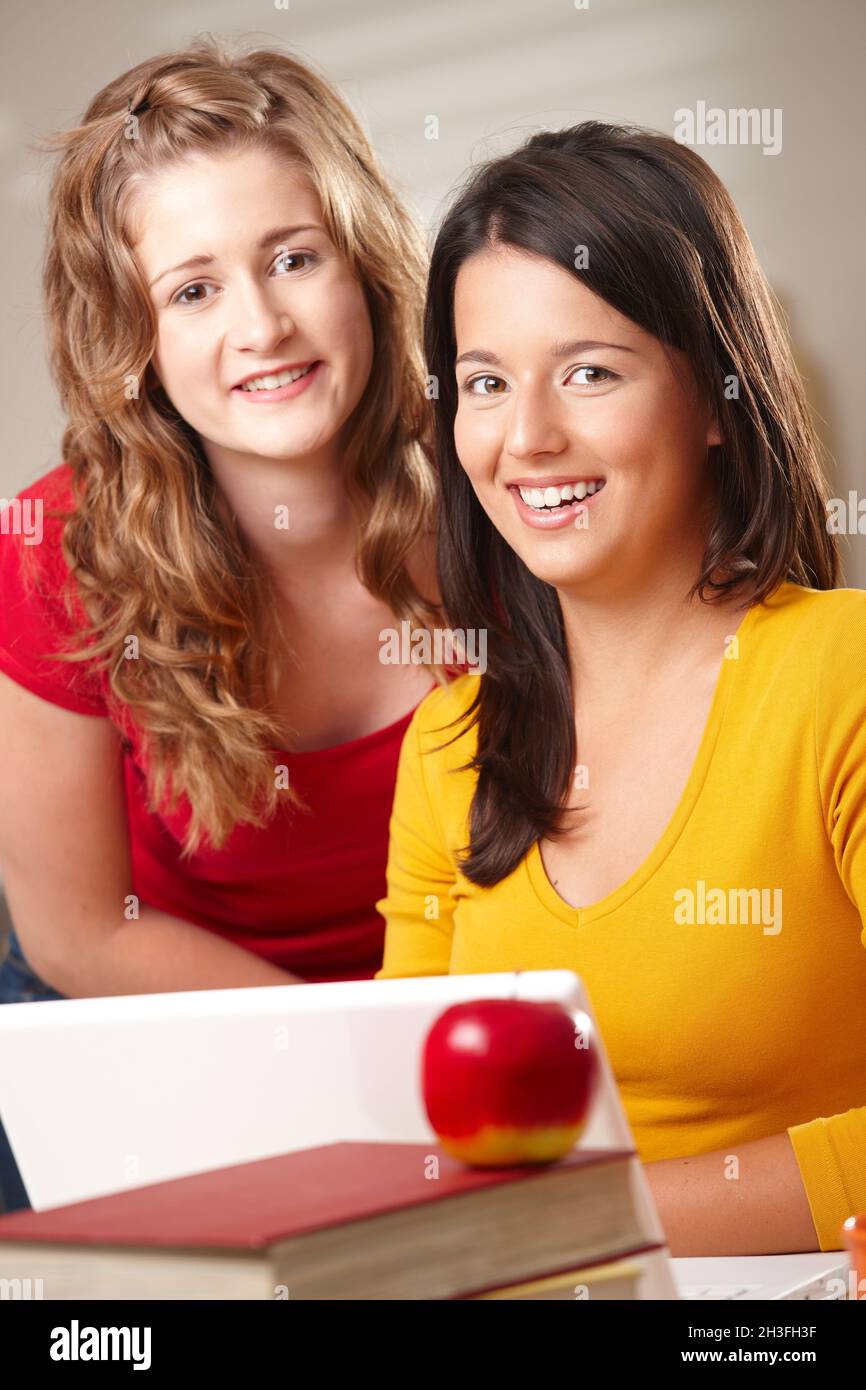 Happy students with laptop Stock Photo - Alamy