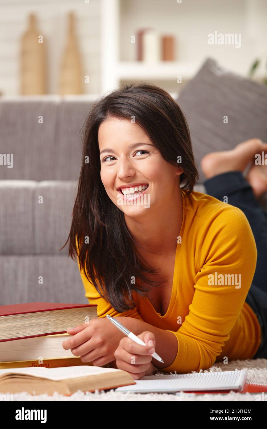 Happy girl learning on floor Stock Photo - Alamy