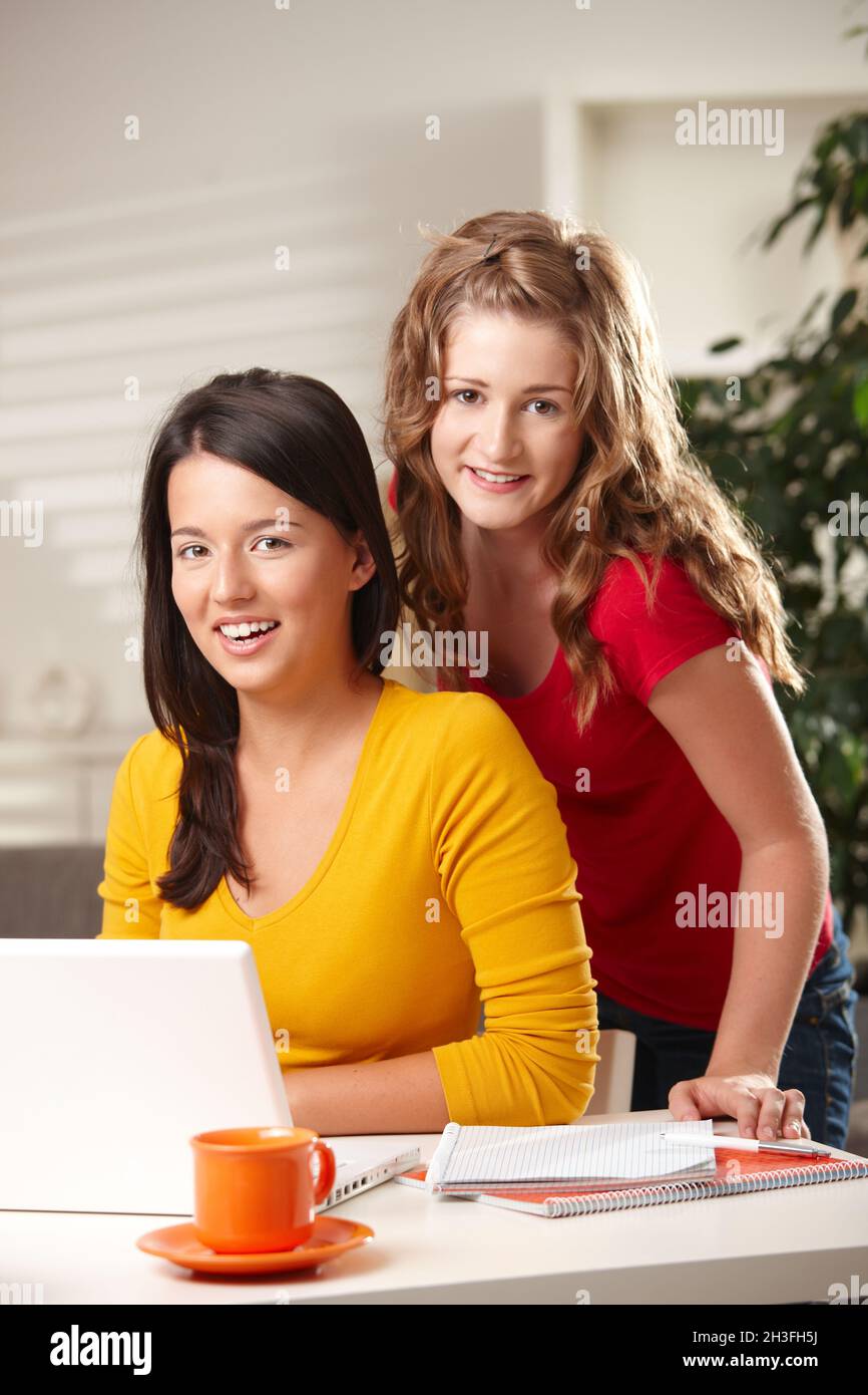 Portrait of two girls with laptop Stock Photo - Alamy