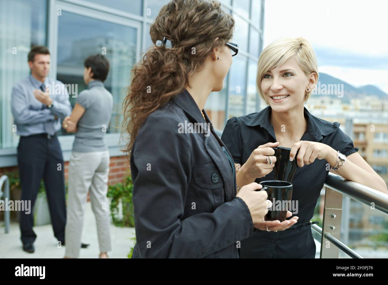 Businesswomen talking outdoor Stock Photo - Alamy