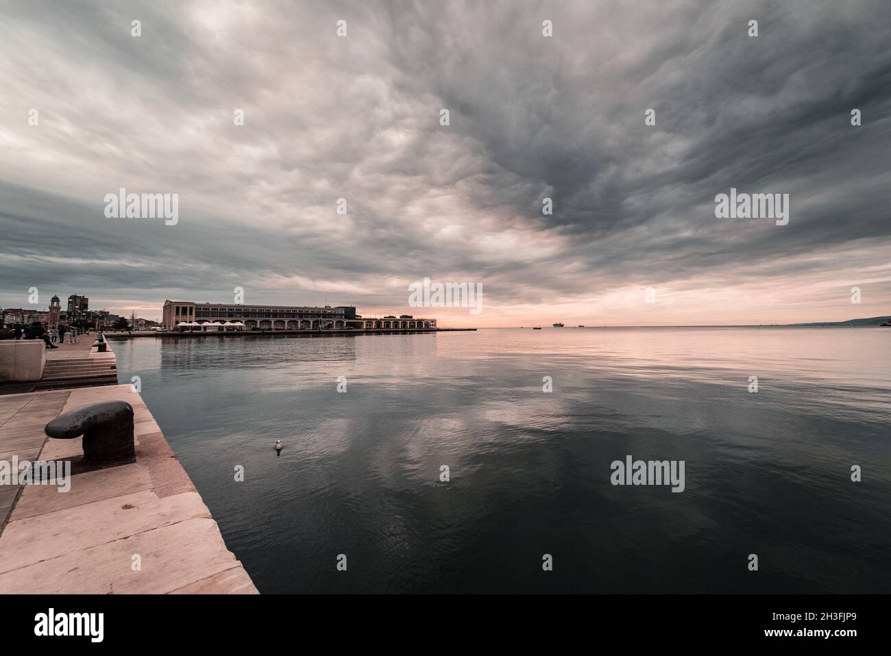 Beautiful sunset scenery in trieste, Italy at the sea with clouds and a ...
