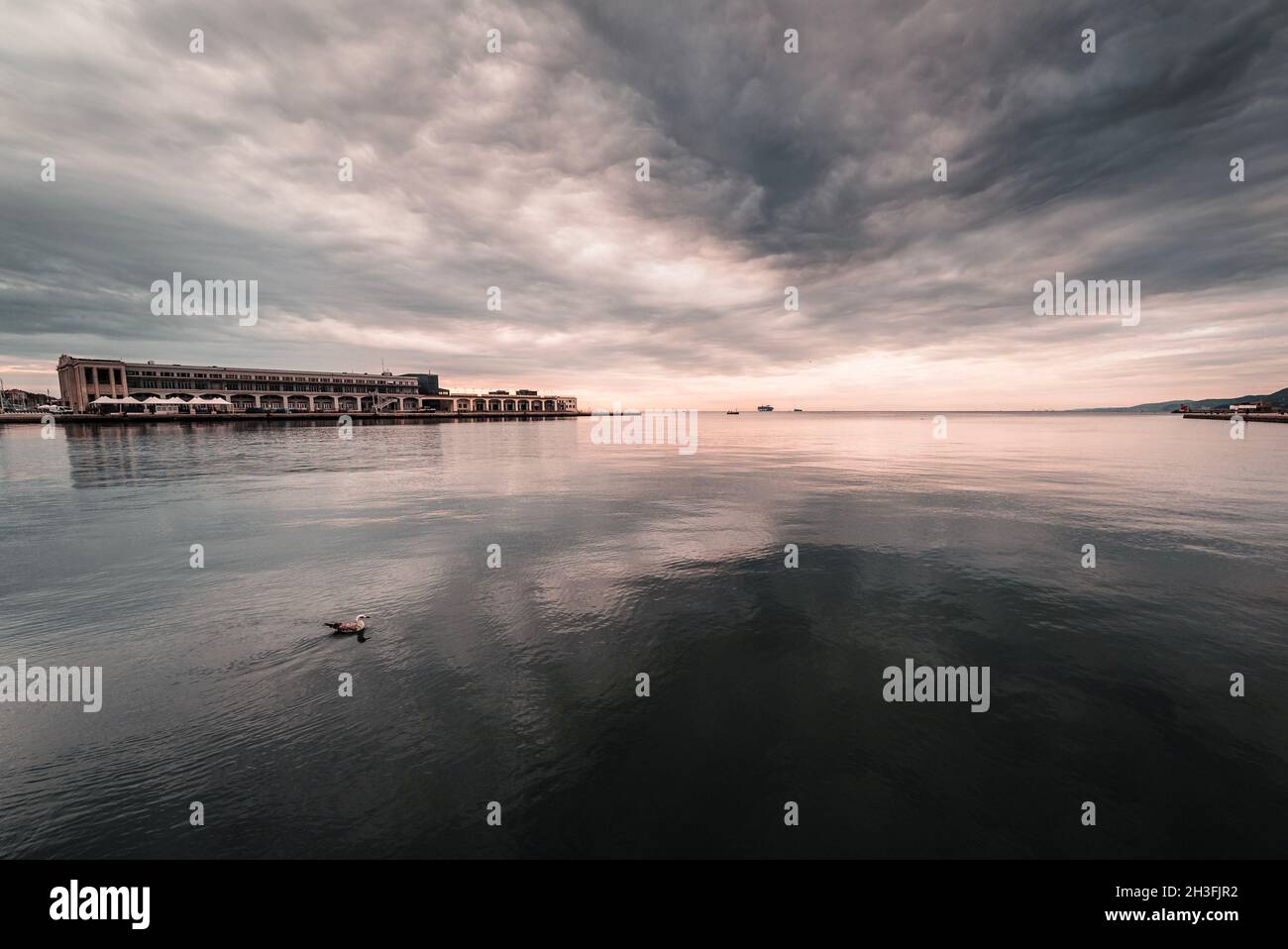 Beautiful sunset scenery in trieste, Italy at the sea with clouds and a ...