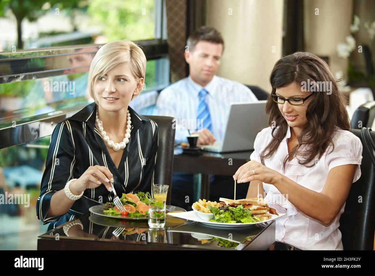 Young women in restaurant Stock Photo - Alamy