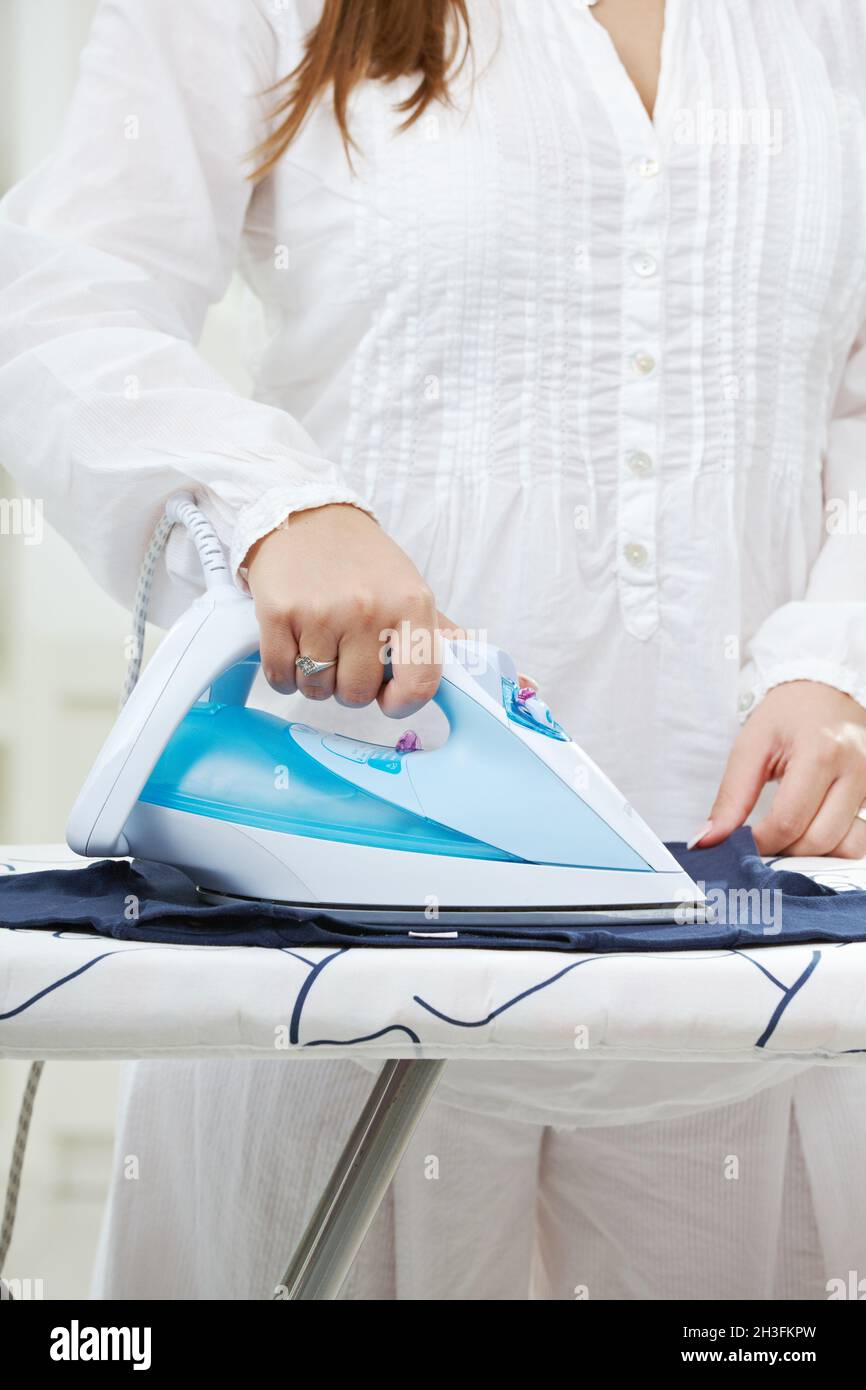 Female hands ironing Stock Photo - Alamy