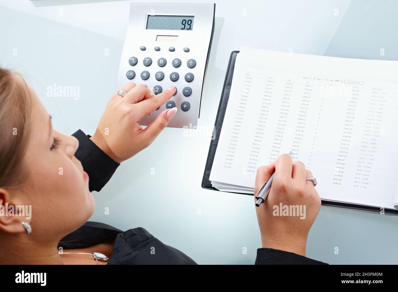 Businesswoman adding up numbers Stock Photo - Alamy