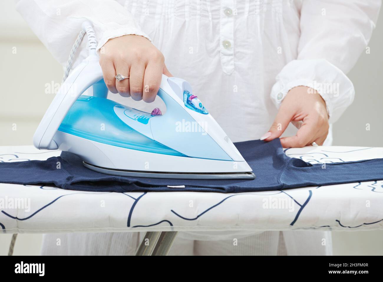 Female hands ironing Stock Photo - Alamy