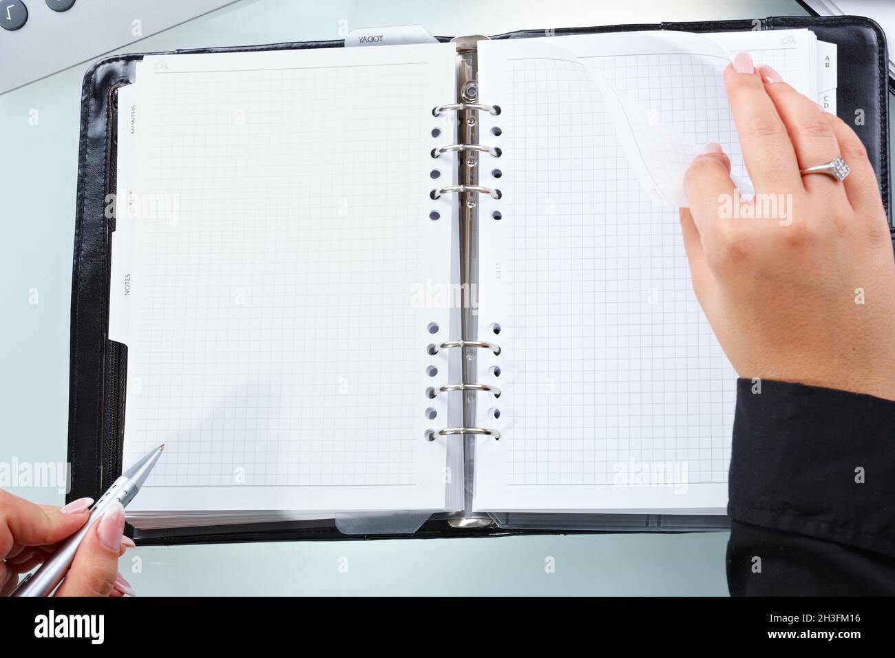 Female hand turning page Stock Photo - Alamy