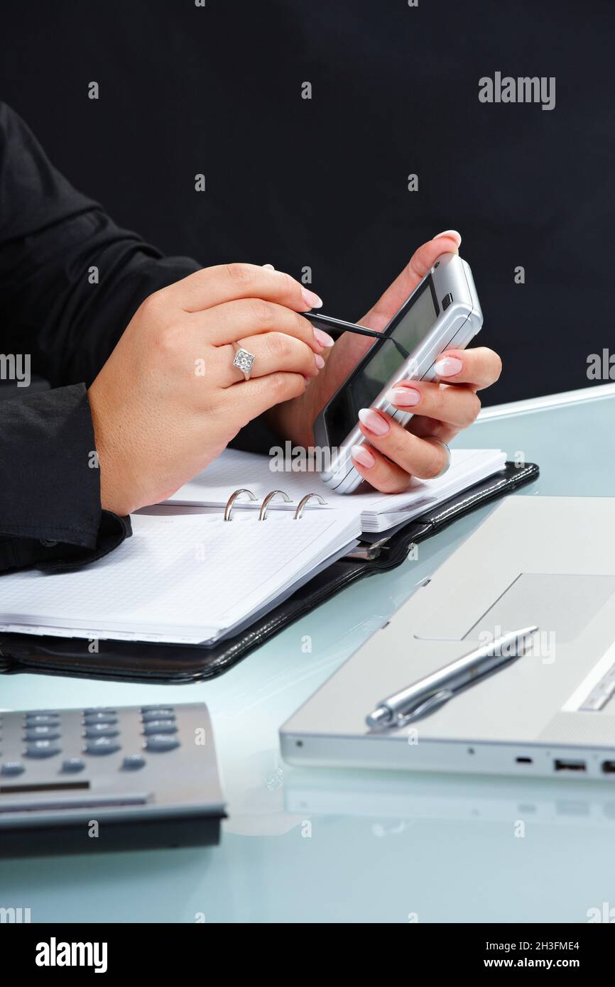 Female hand using handheld Stock Photo - Alamy