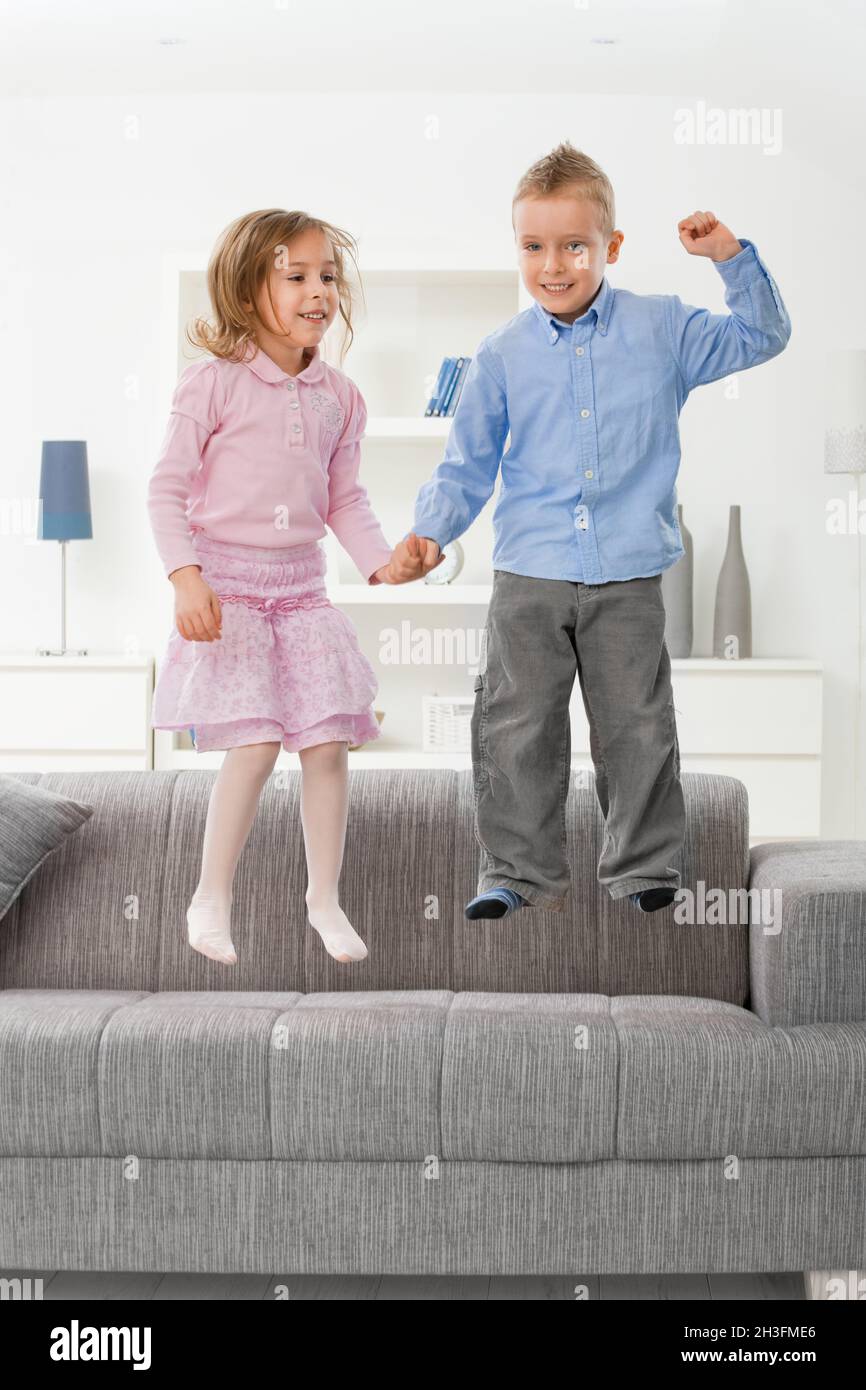 Children jumping on couch Stock Photo - Alamy
