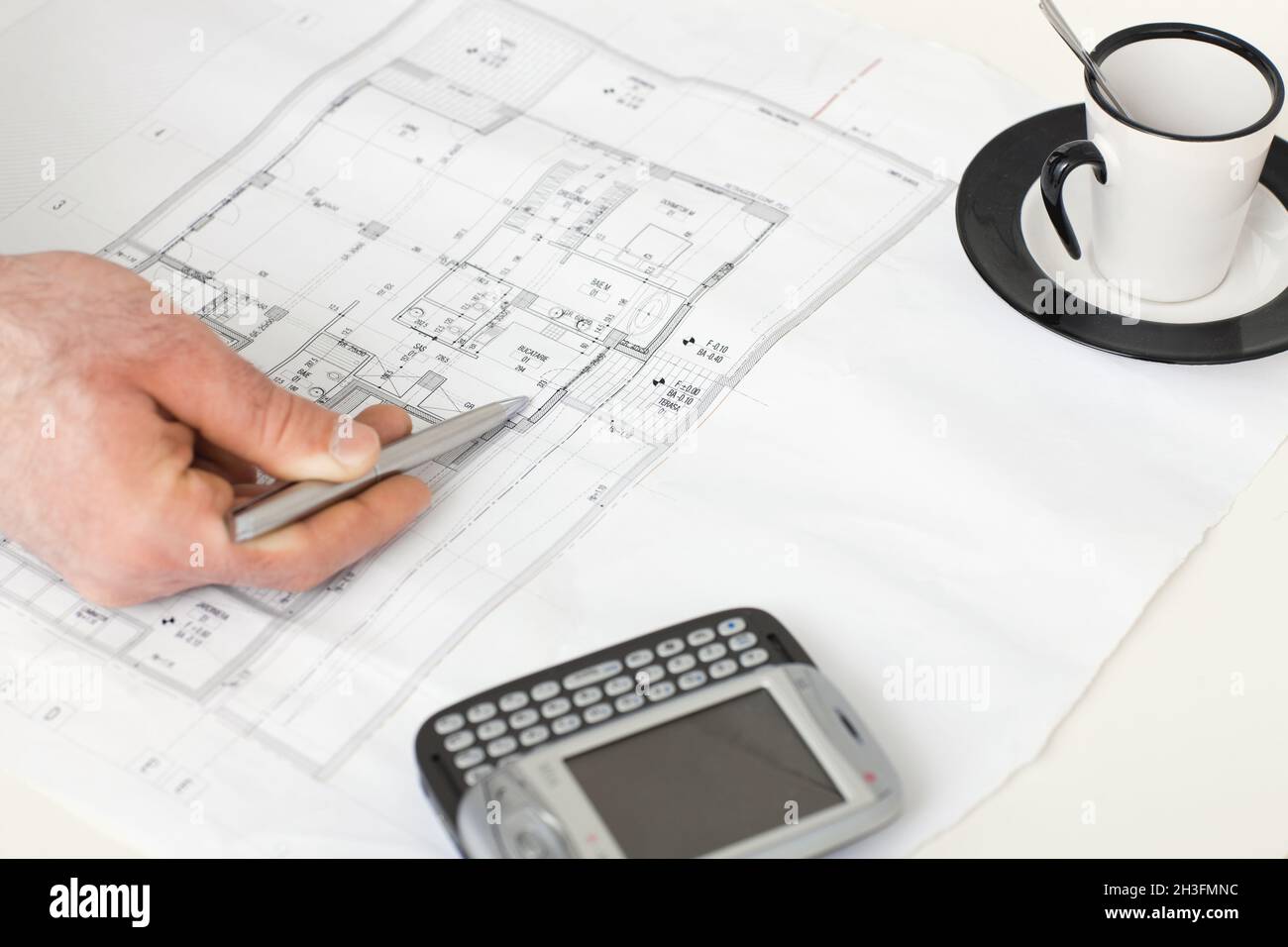 Floor plan on architect's desk Stock Photo - Alamy