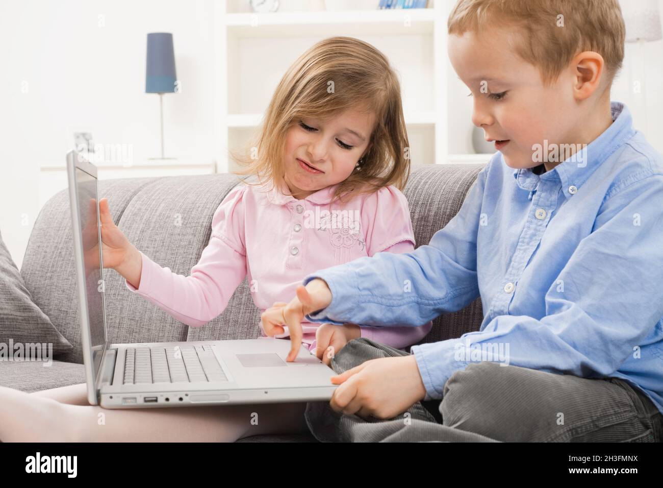 Boy sitting typing laptop indoor hi-res stock photography and images ...