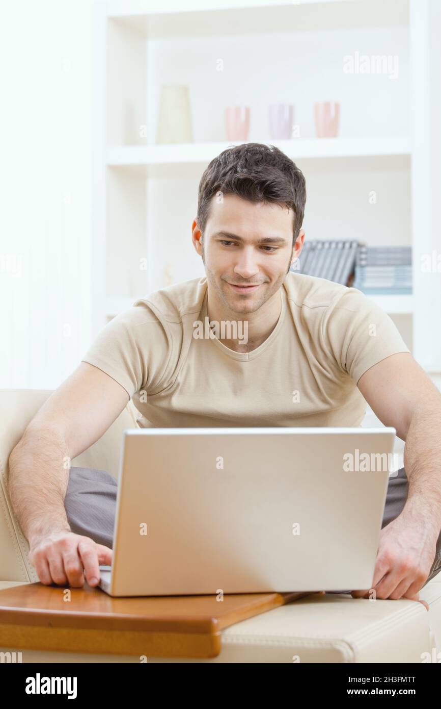 Happy man using computer Stock Photo - Alamy