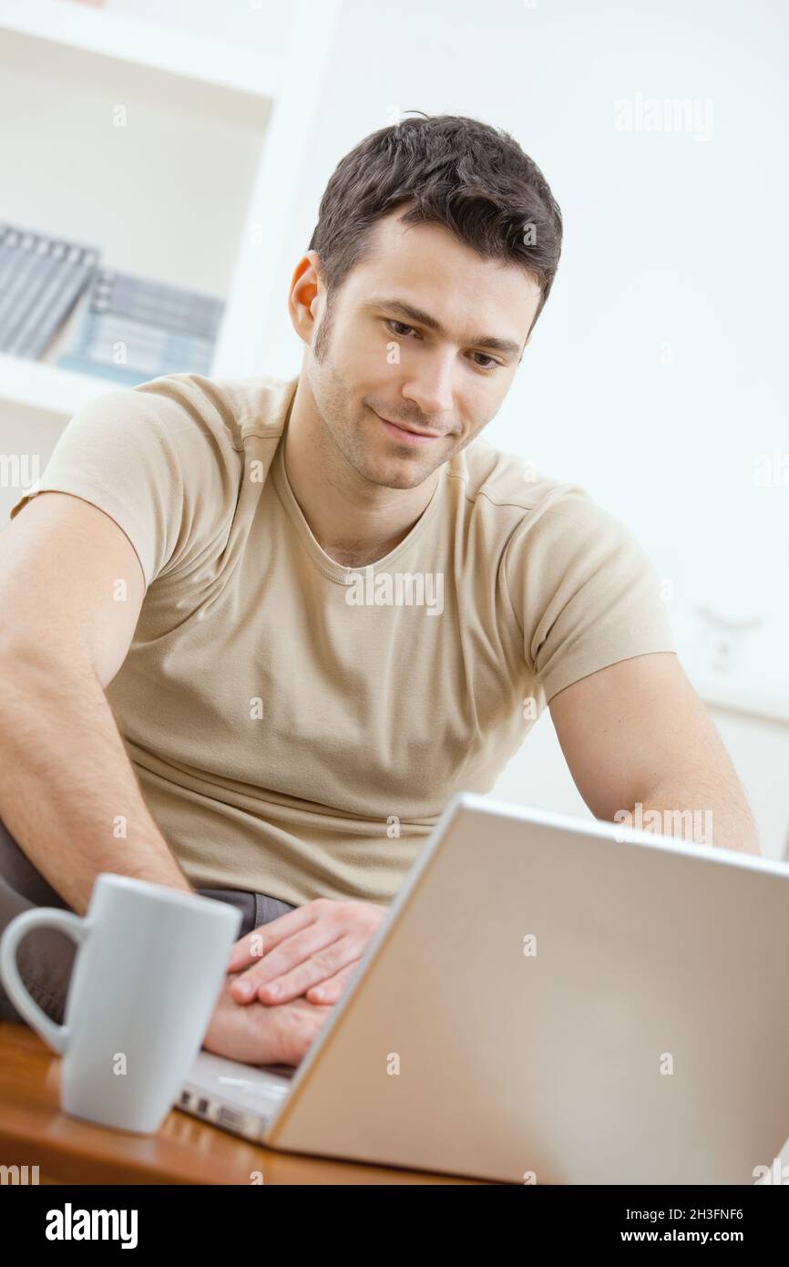 Happy man using computer Stock Photo - Alamy
