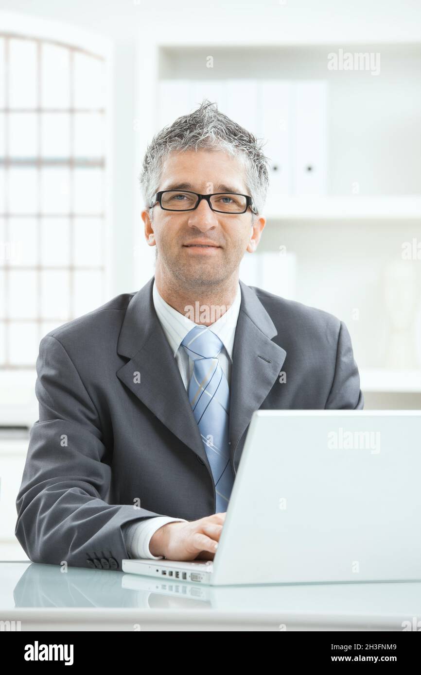 Businessman working at desk Stock Photo - Alamy