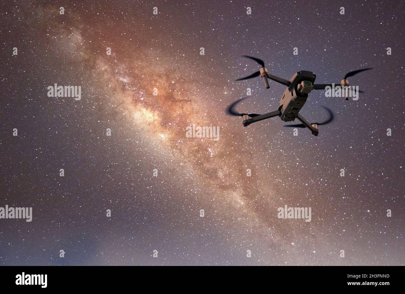 Drone flying at night against dark sky Stock Photo - Alamy
