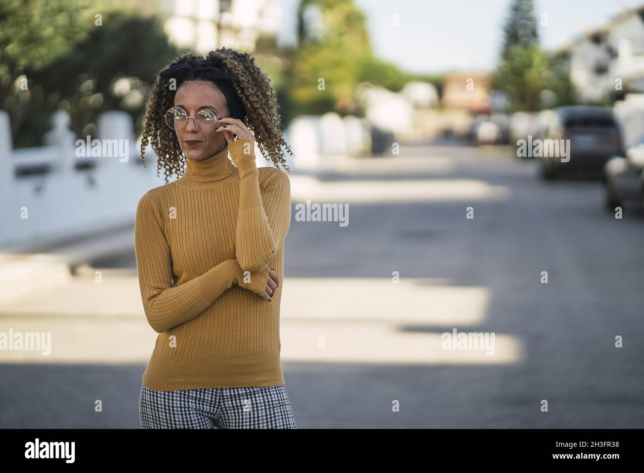 Spanish female posing in the street Stock Photo - Alamy
