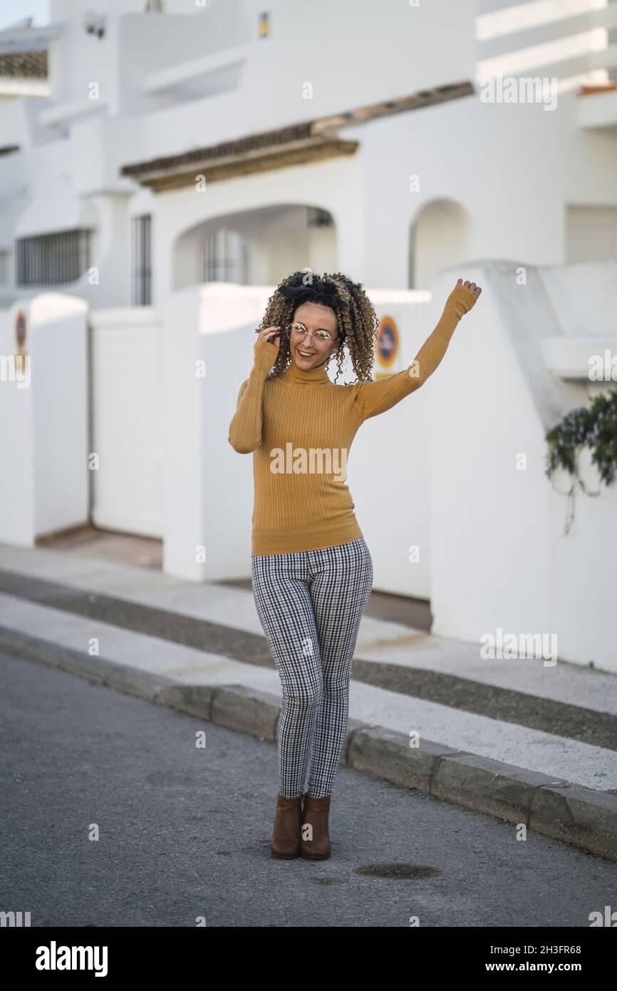 Vertical shot of a Spanish female posing near the building Stock Photo ...
