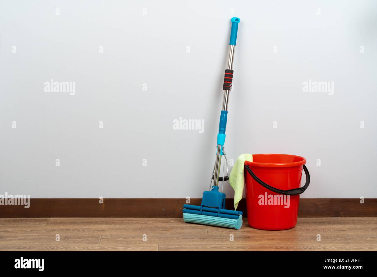 Cleaning tools for house cleaning on wooden floor Stock Photo - Alamy