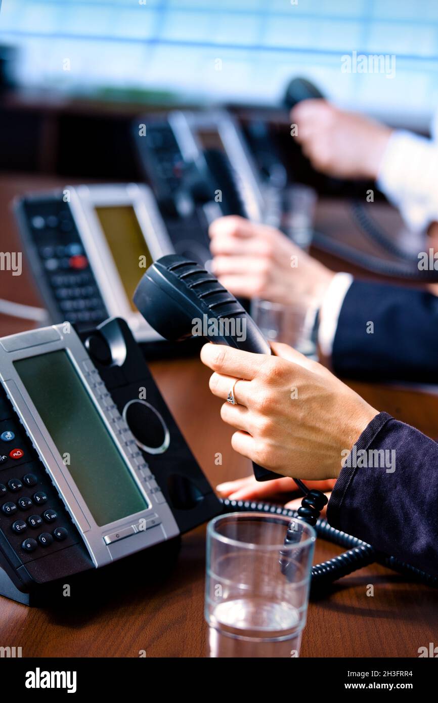 Hands holding phones Stock Photo - Alamy