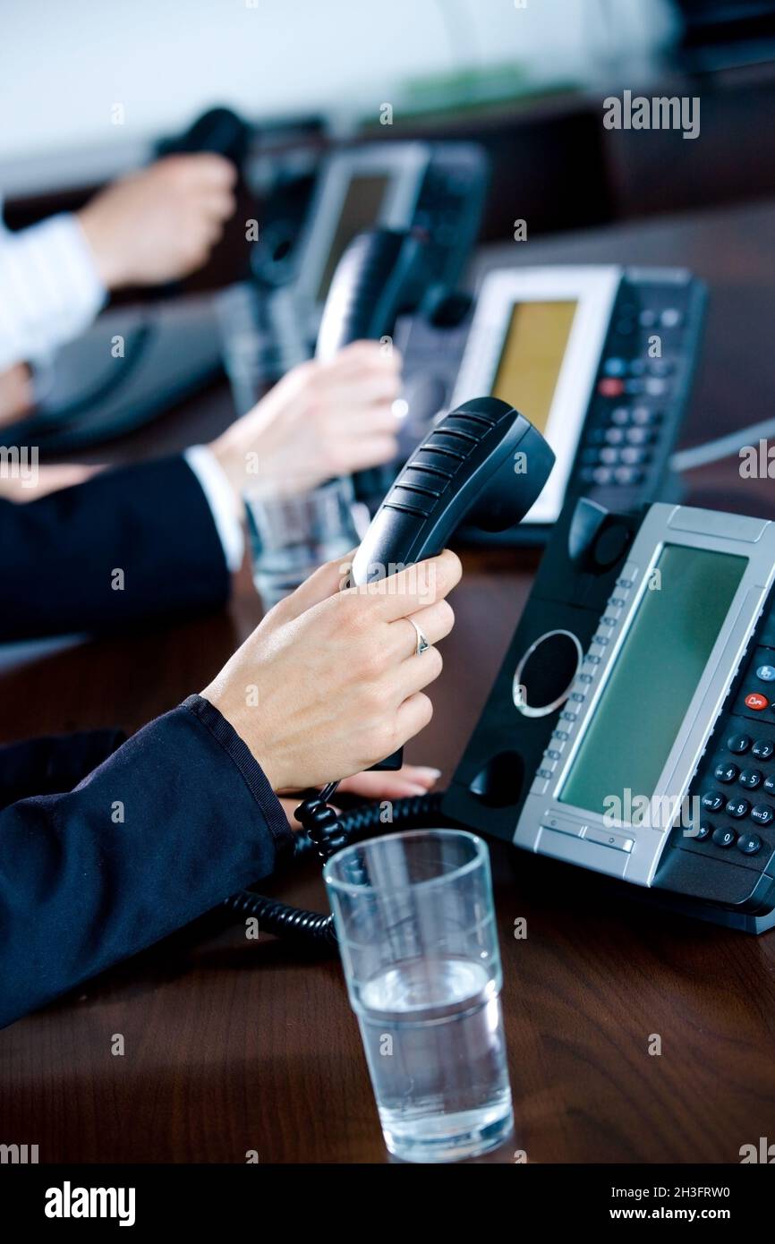 Hands holding phones Stock Photo - Alamy