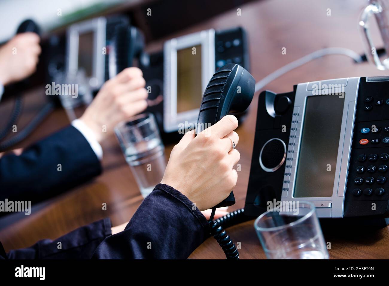 Hands holding phones Stock Photo - Alamy