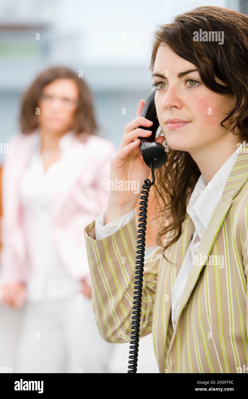 Receptionist receiving phone calls Stock Photo - Alamy