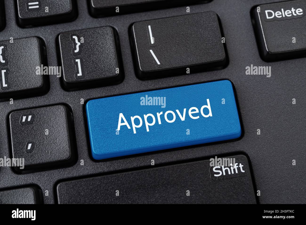 Approved blue key on the black pc keyboard. Concept of business project ...