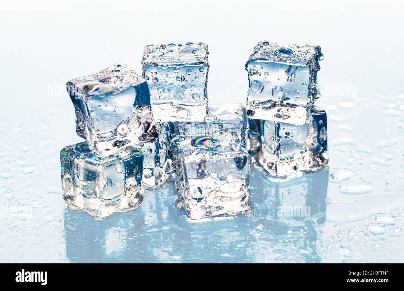 Square melting ice cubes on wet table Stock Photo - Alamy
