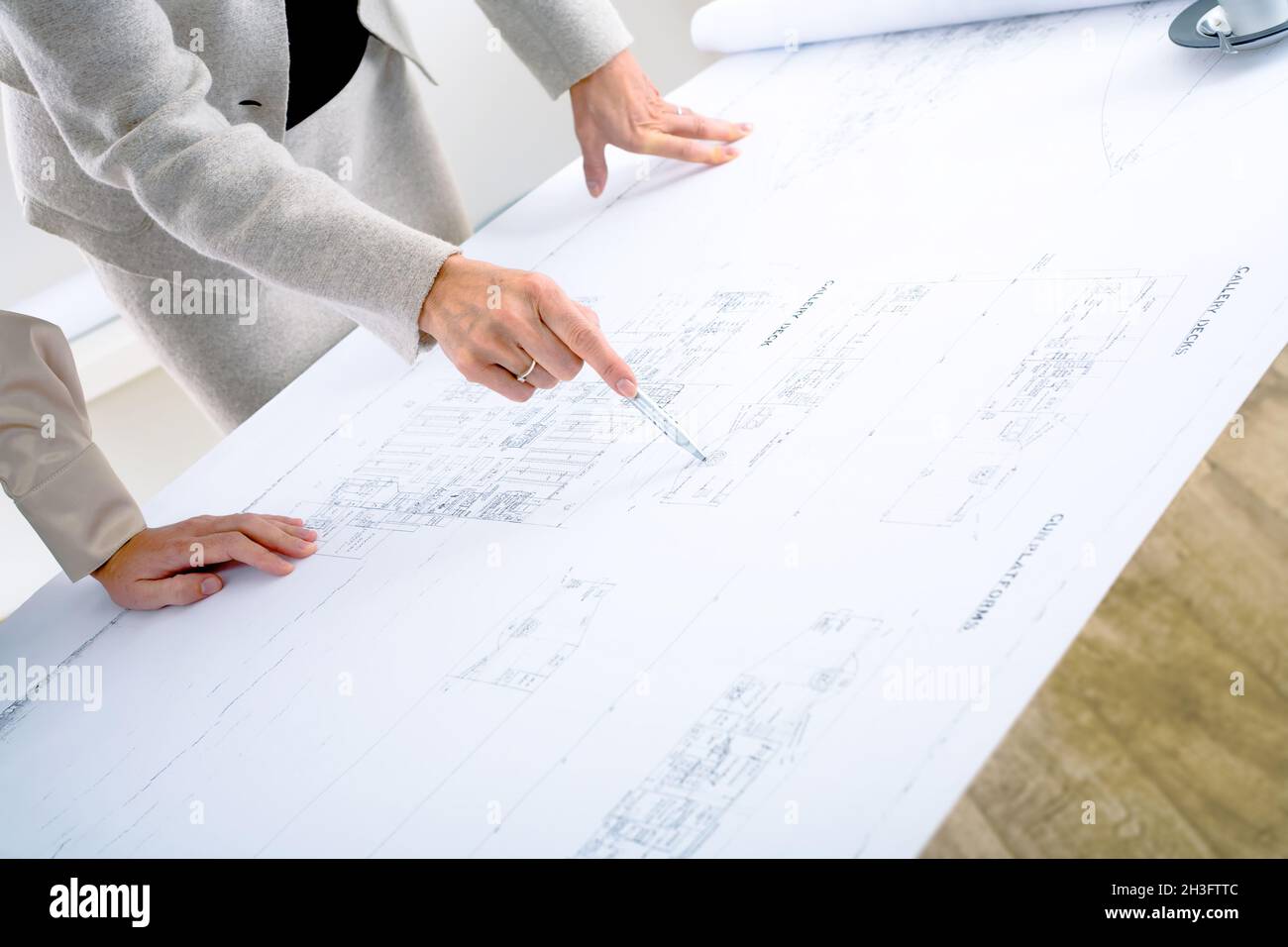 Architects planning on blueprint Stock Photo - Alamy