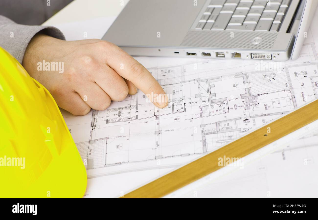 Floor plan on architect's desk Stock Photo - Alamy
