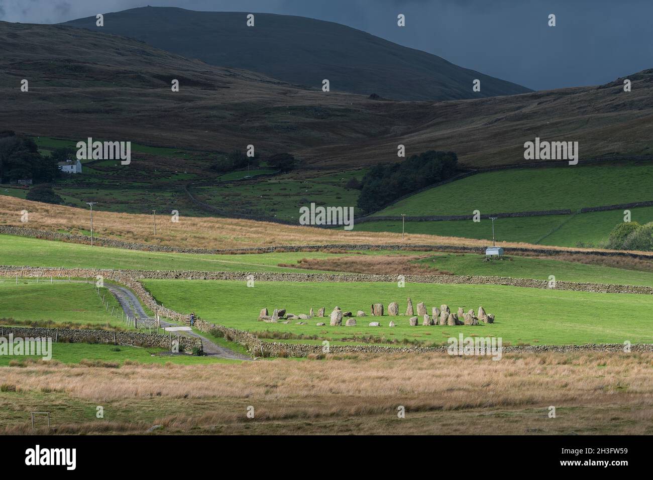 Swinside, aka Sunkenkirk stone circle in bright sun; background hill in ...