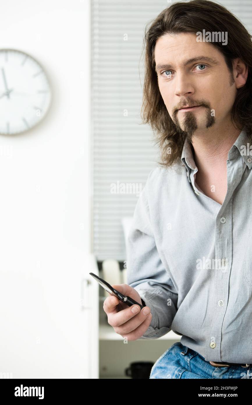 Office worker using mobile phone Stock Photo - Alamy