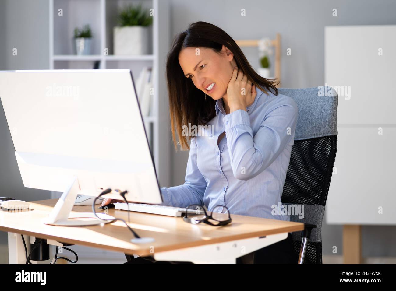 Bad Posture Neck Pain In Chair. Woman Suffering Stock Photo - Alamy