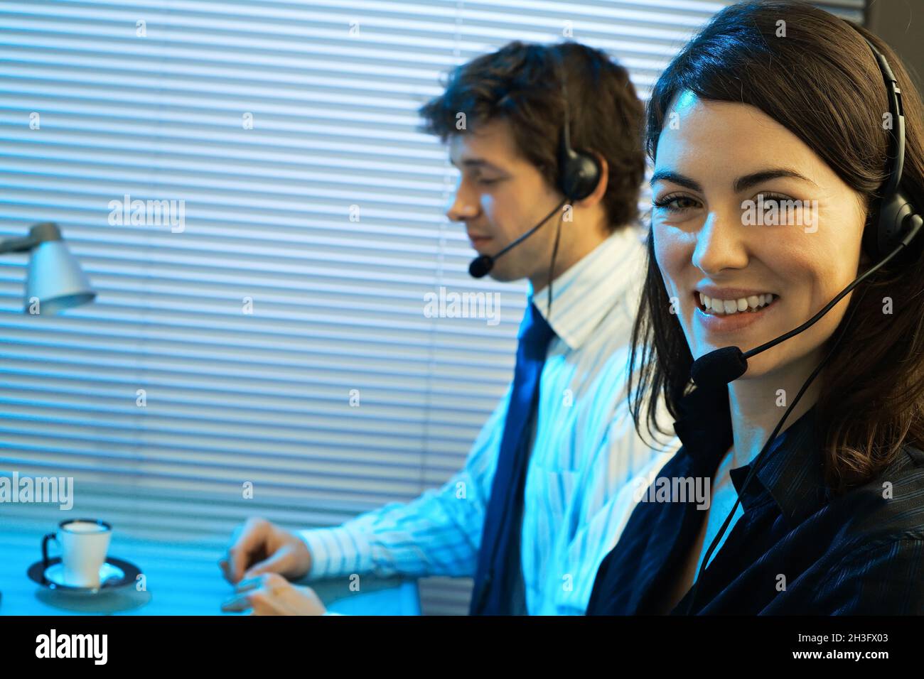 Operators talking on headset Stock Photo - Alamy