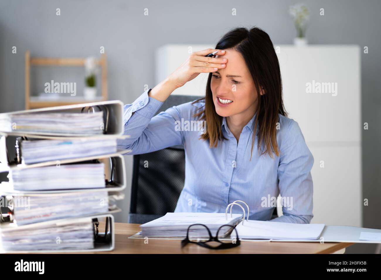 Frustrated Bored Accountant Female Employee At Desk Stock Photo - Alamy