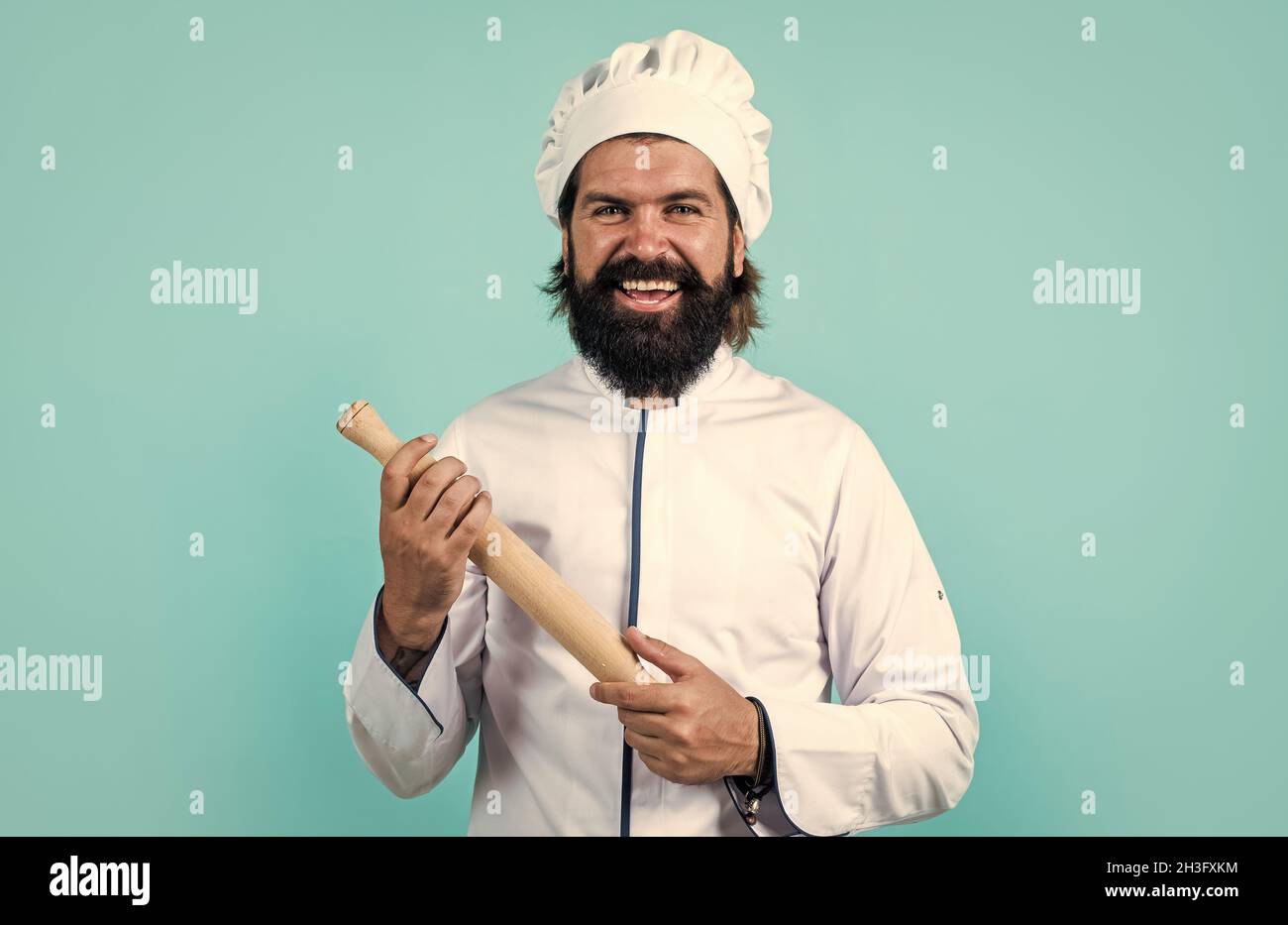 happy guy chef in hat with beard and moustache on blue background use ...