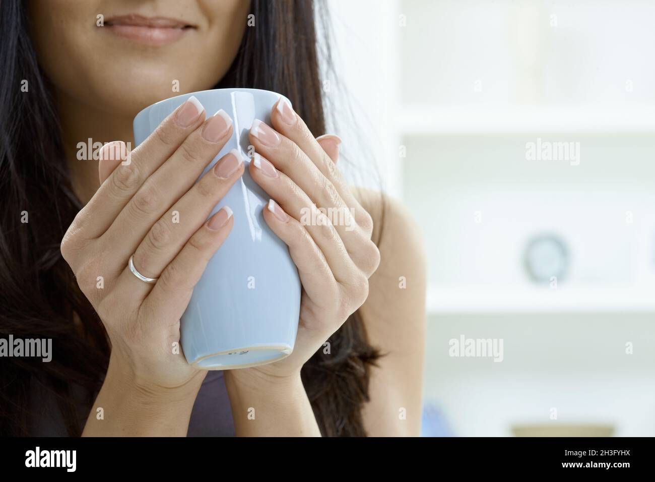Female hands holding tea cup Stock Photo - Alamy